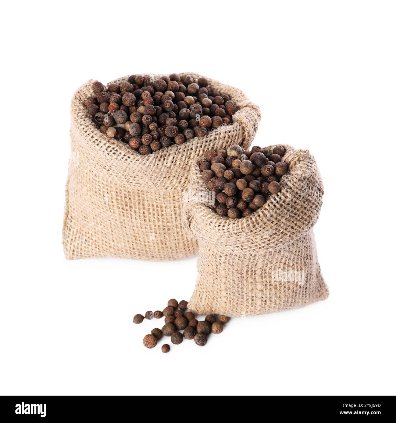 Burlap sacks with allspice isolated on white Stock Photo - Alamy