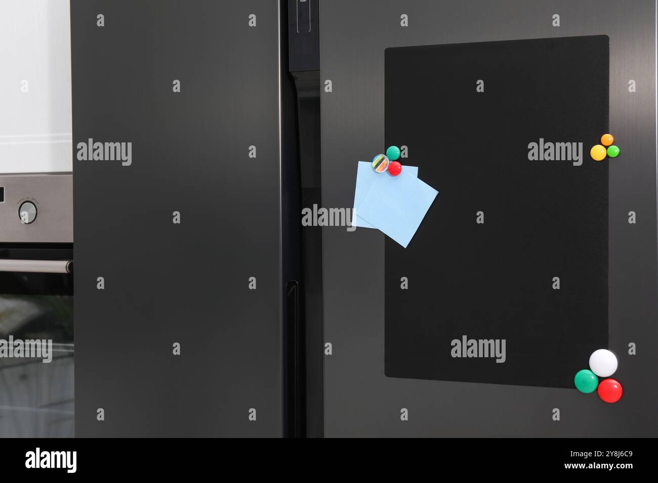 Magnetic board and notes on refrigerator in kitchen Stock Photo - Alamy