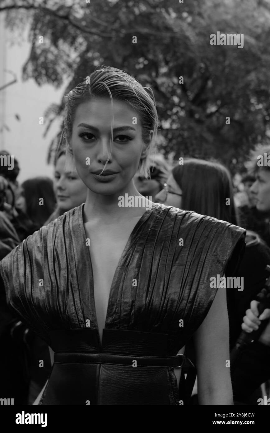 Michelle Dee wearing a sleeveless jumpsuit with a midwaist belt at the ...