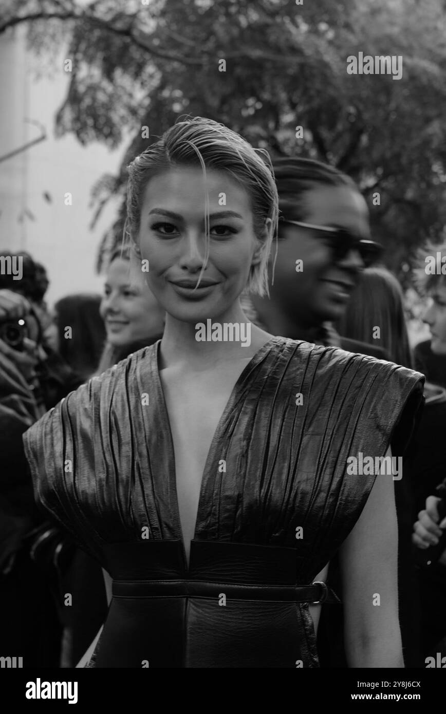 Michelle Dee wearing a sleeveless jumpsuit with a midwaist belt at the ...