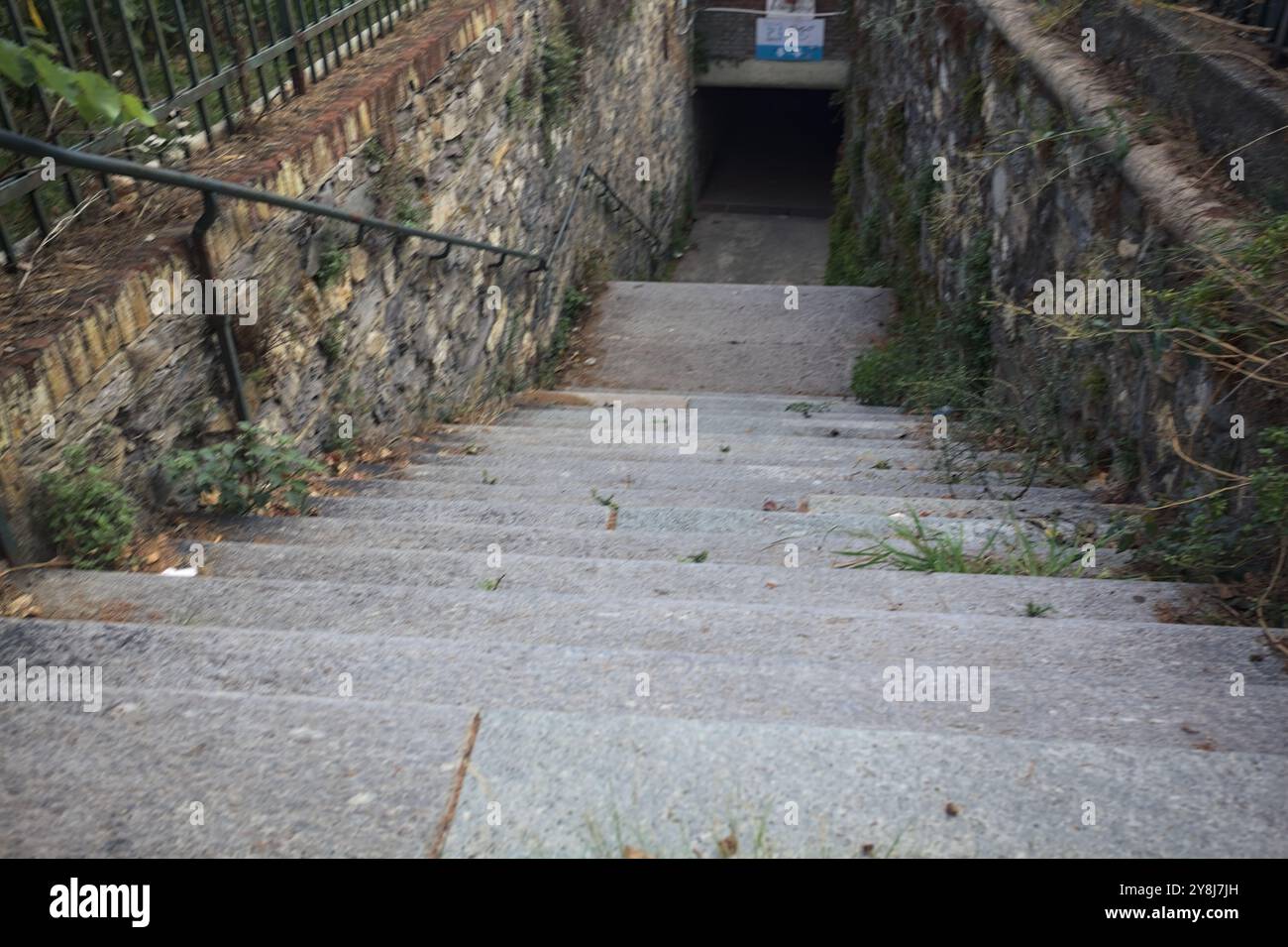 Descending stone staircase that leads to an underpass in an italian ...
