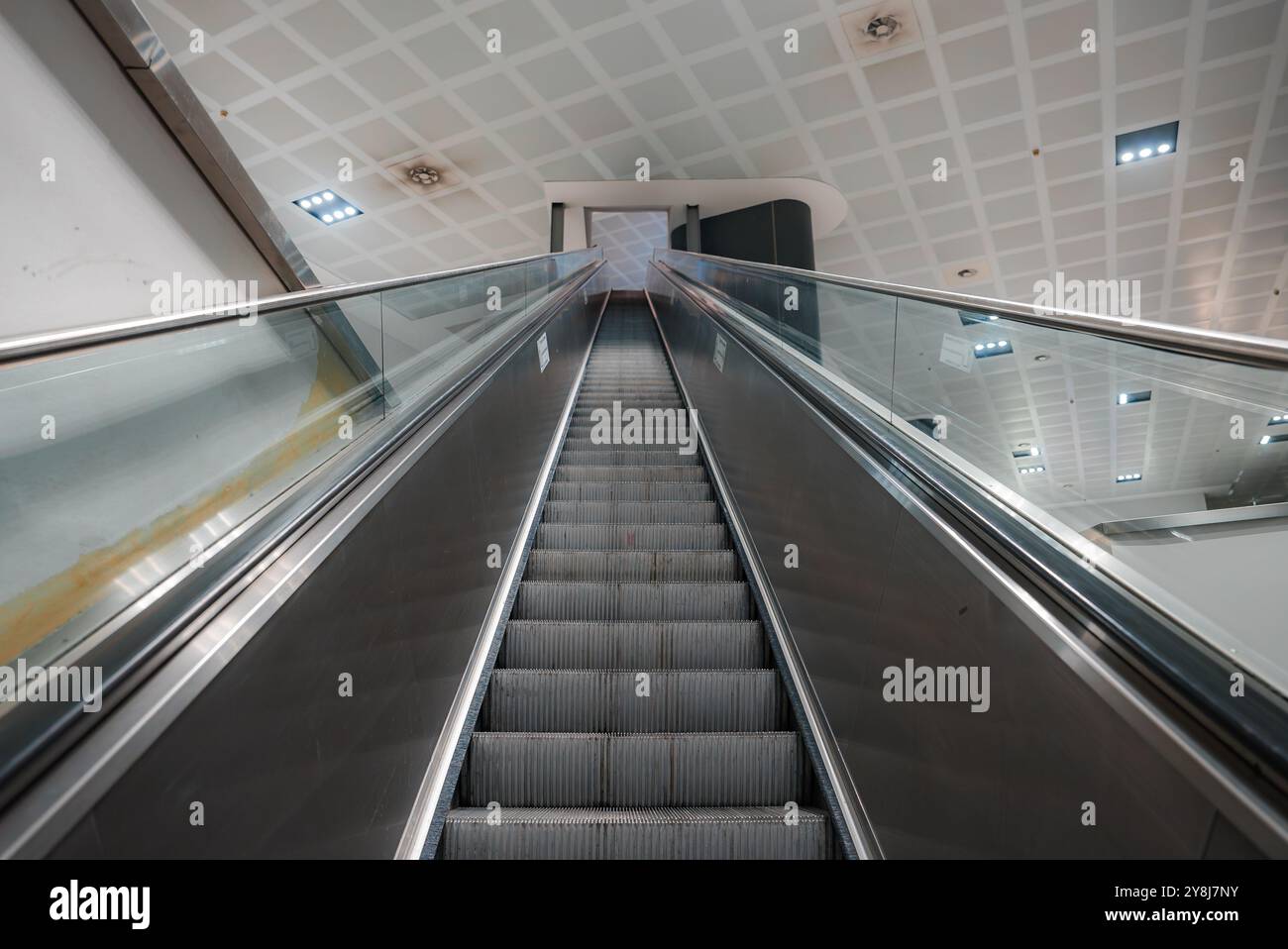 Modern Escalator with Glass Railings in Sardinian Commercial Space ...