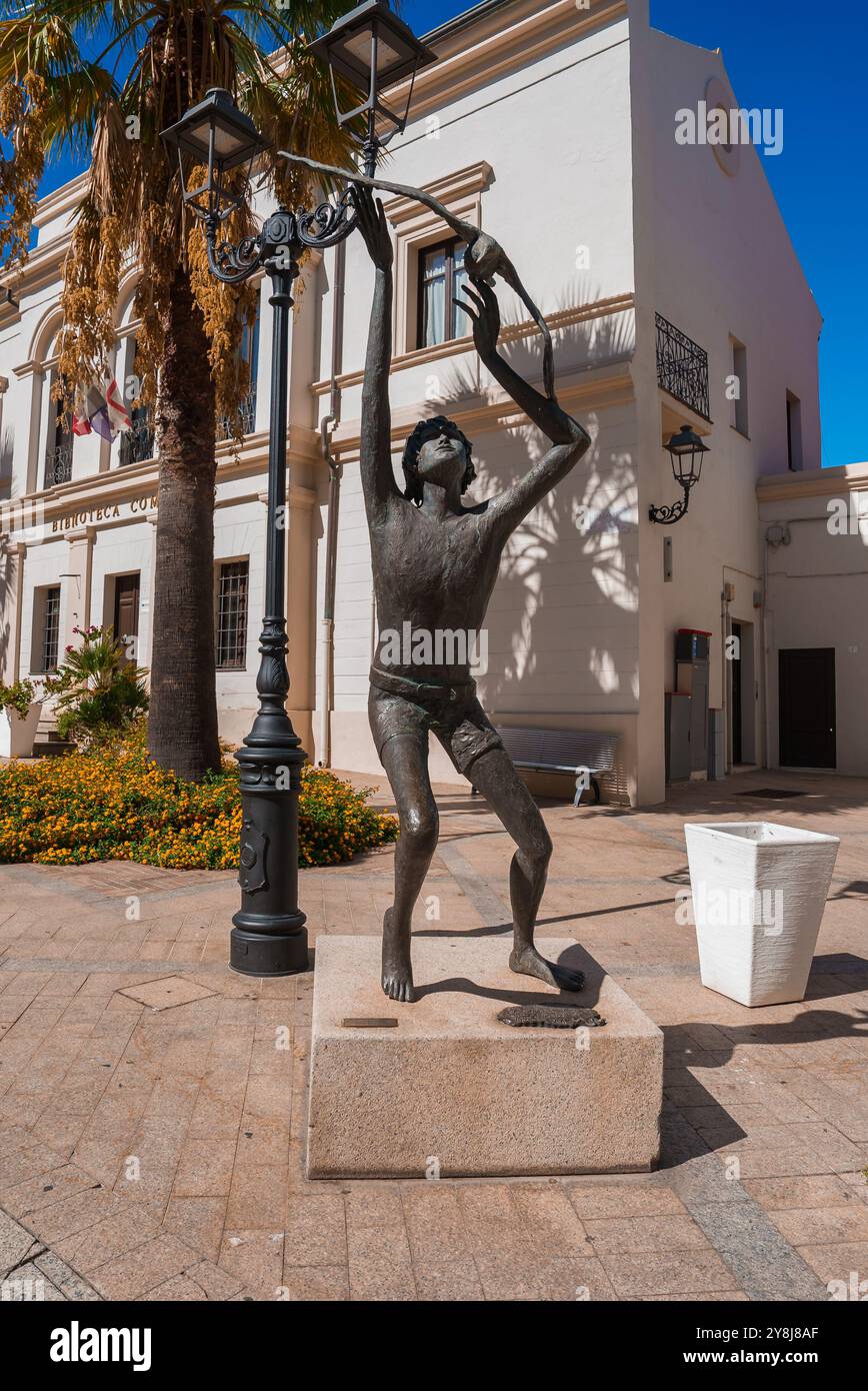 Bronze Statue in Sunlit Plaza with Mediterranean Architecture in ...