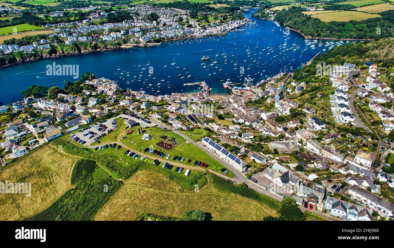 Aerial view of a picturesque coastal village with a marina, surrounded ...