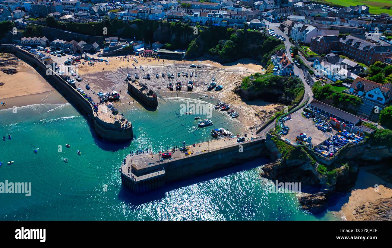 Aerial view of a coastal harbor with boats, sandy beach, and ...