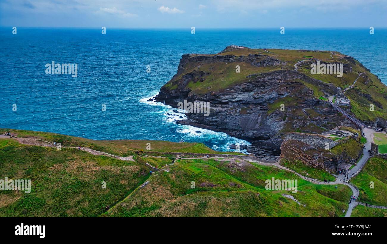 Aerial view of a rugged coastal landscape featuring a rocky cliff with ...