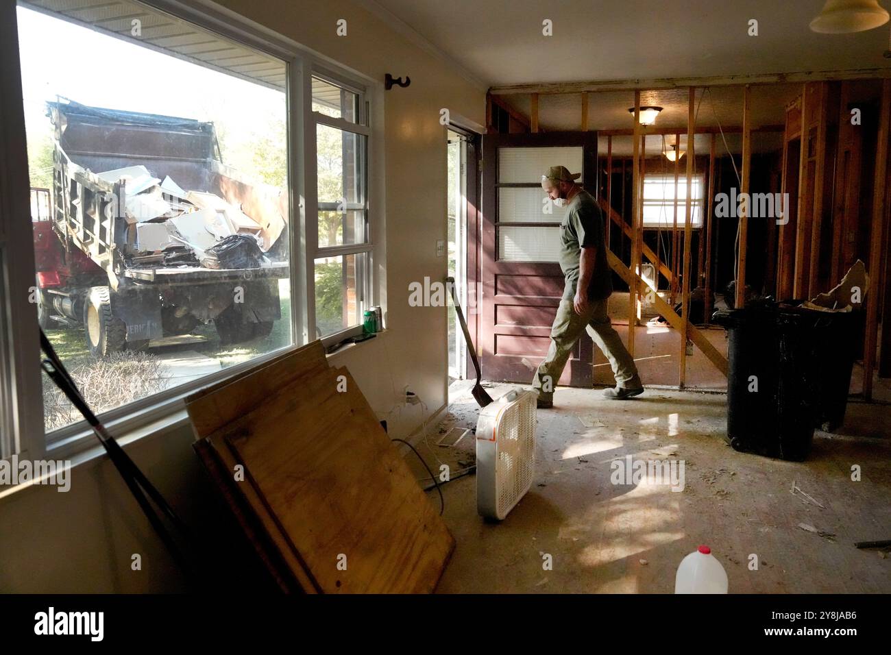 Christopher Moore walks out the front door of his home as he works to ...