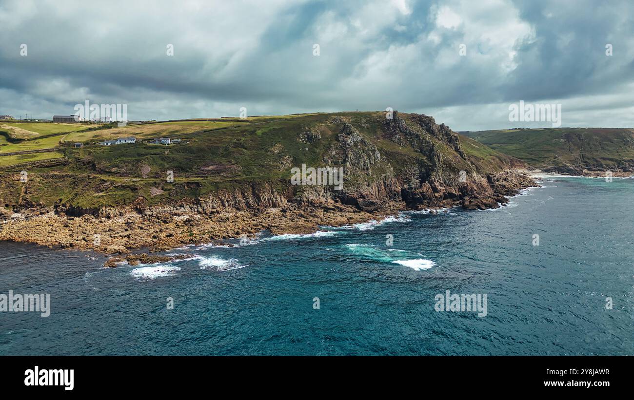 A scenic coastal view featuring rugged cliffs and rocky shorelines. The ...