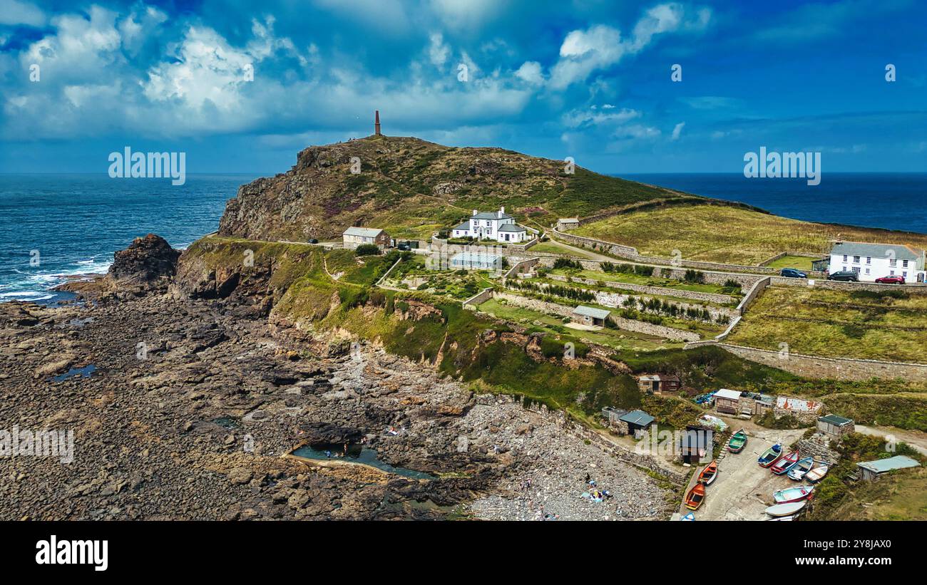Aerial view of a coastal landscape featuring a rocky shore, a ...