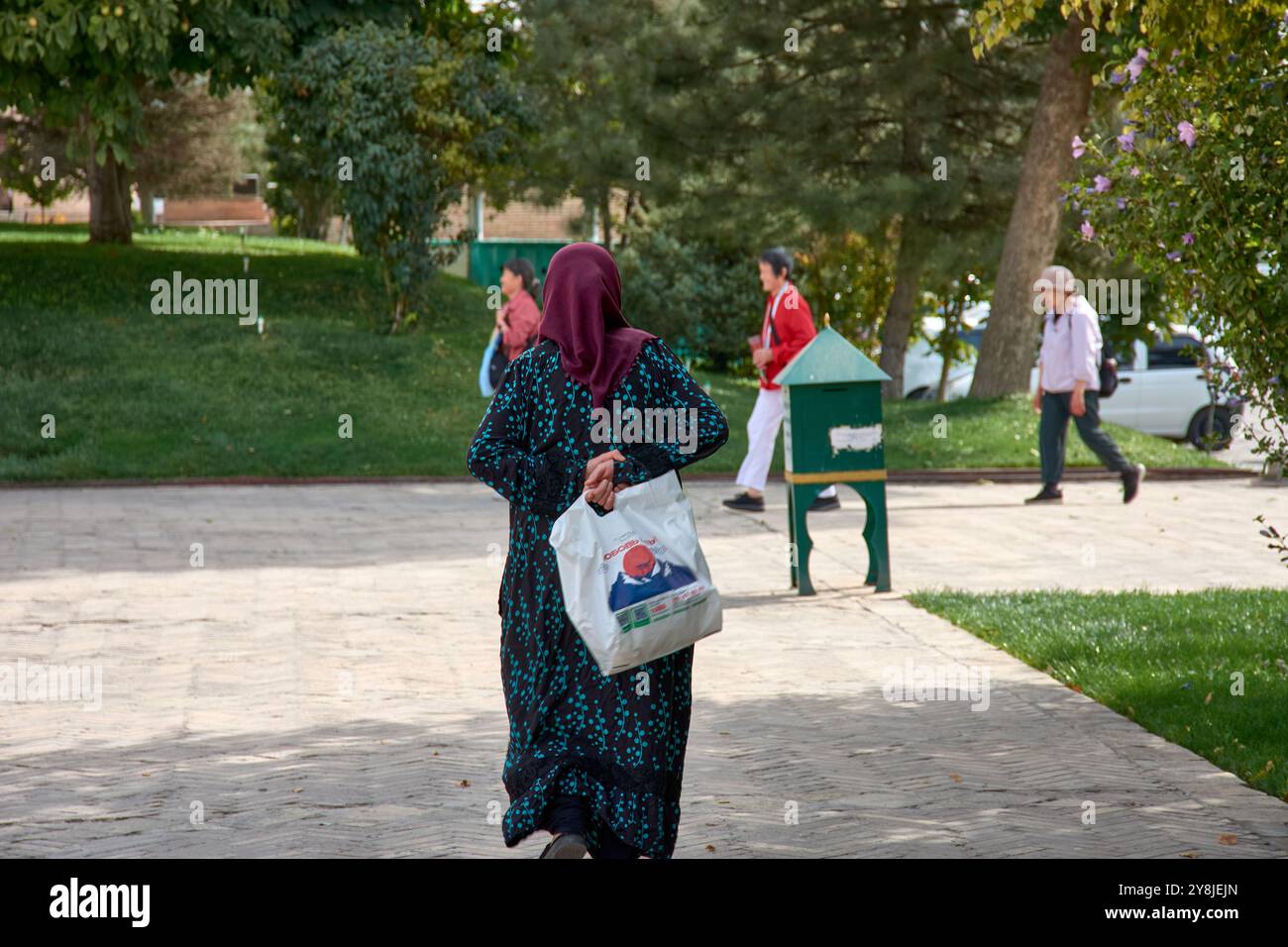 Tashkent,Uzbekistan;September,16,2024:a Muslim woman wearing a maroon ...