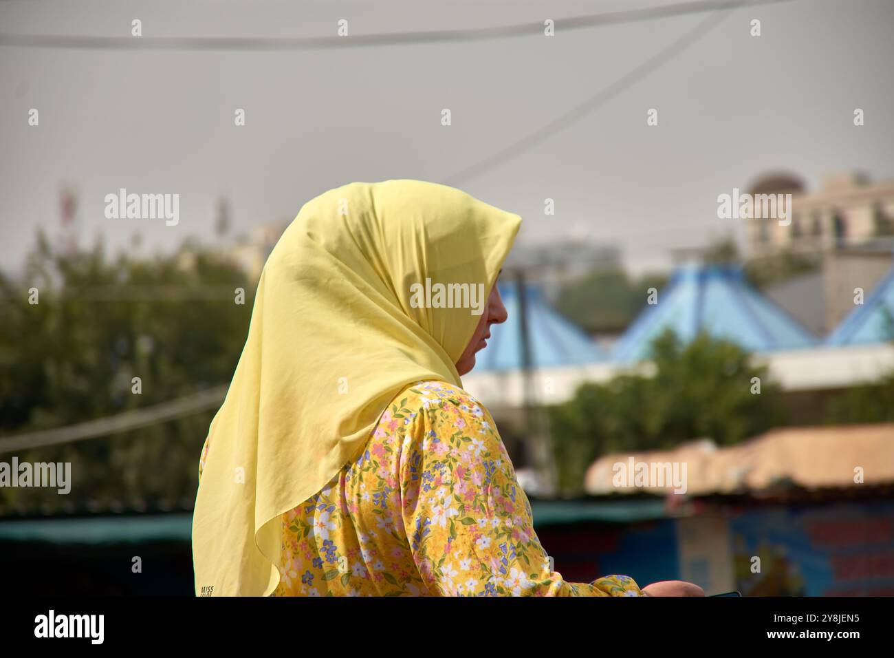 Tashkent,Uzbekistan;September,16,2024:a Muslim woman wearing a yellow ...