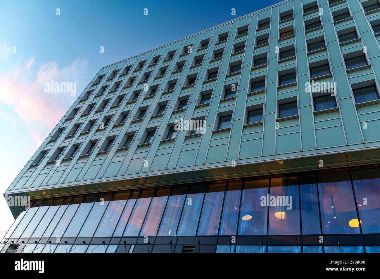 A modern office building with a geometric design is captured during ...