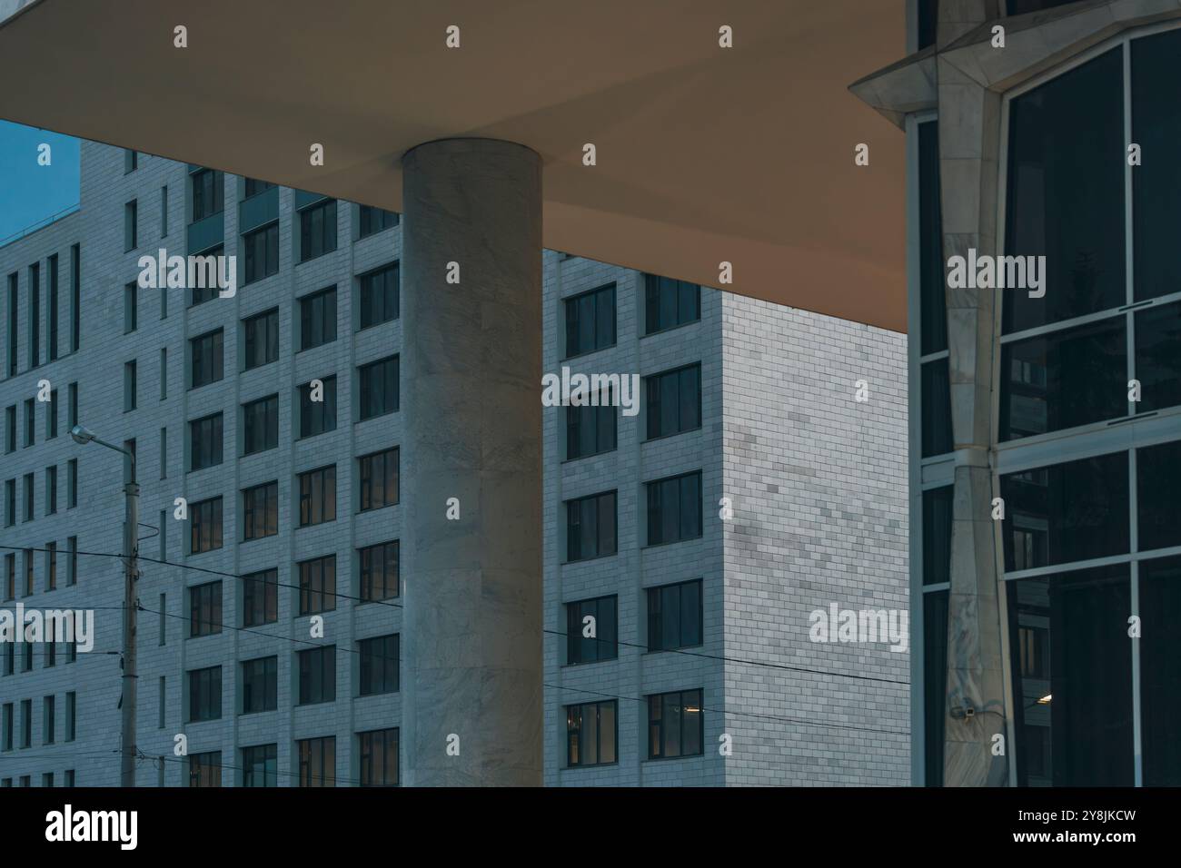 An abstract view of modern office buildings featuring columns and large ...