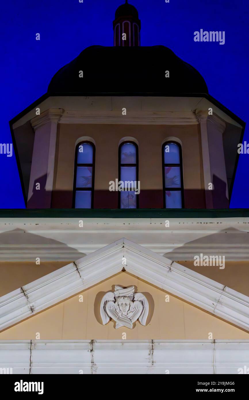 The facade of a historic building with an illuminated dome is captured ...