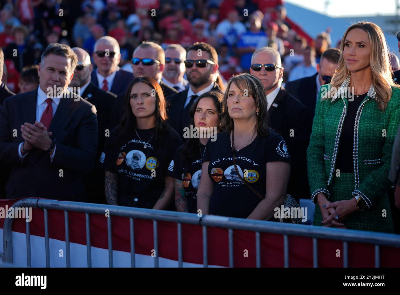 Family members of Corey Comperatore, including his wife Helen, second from right, stand with ...