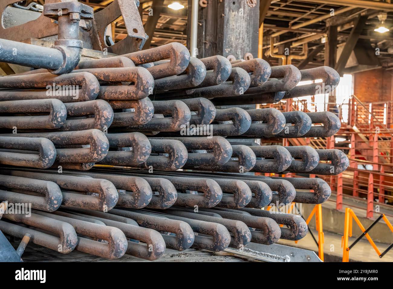 Maintenance being completed on metal piping from boiler coils and ...