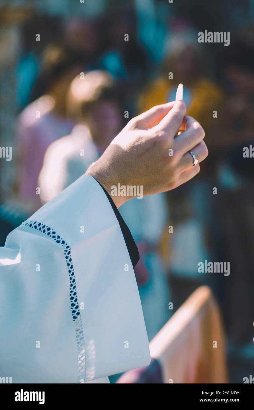 catholic priest holding host aloft at communion ceremony Stock Photo ...