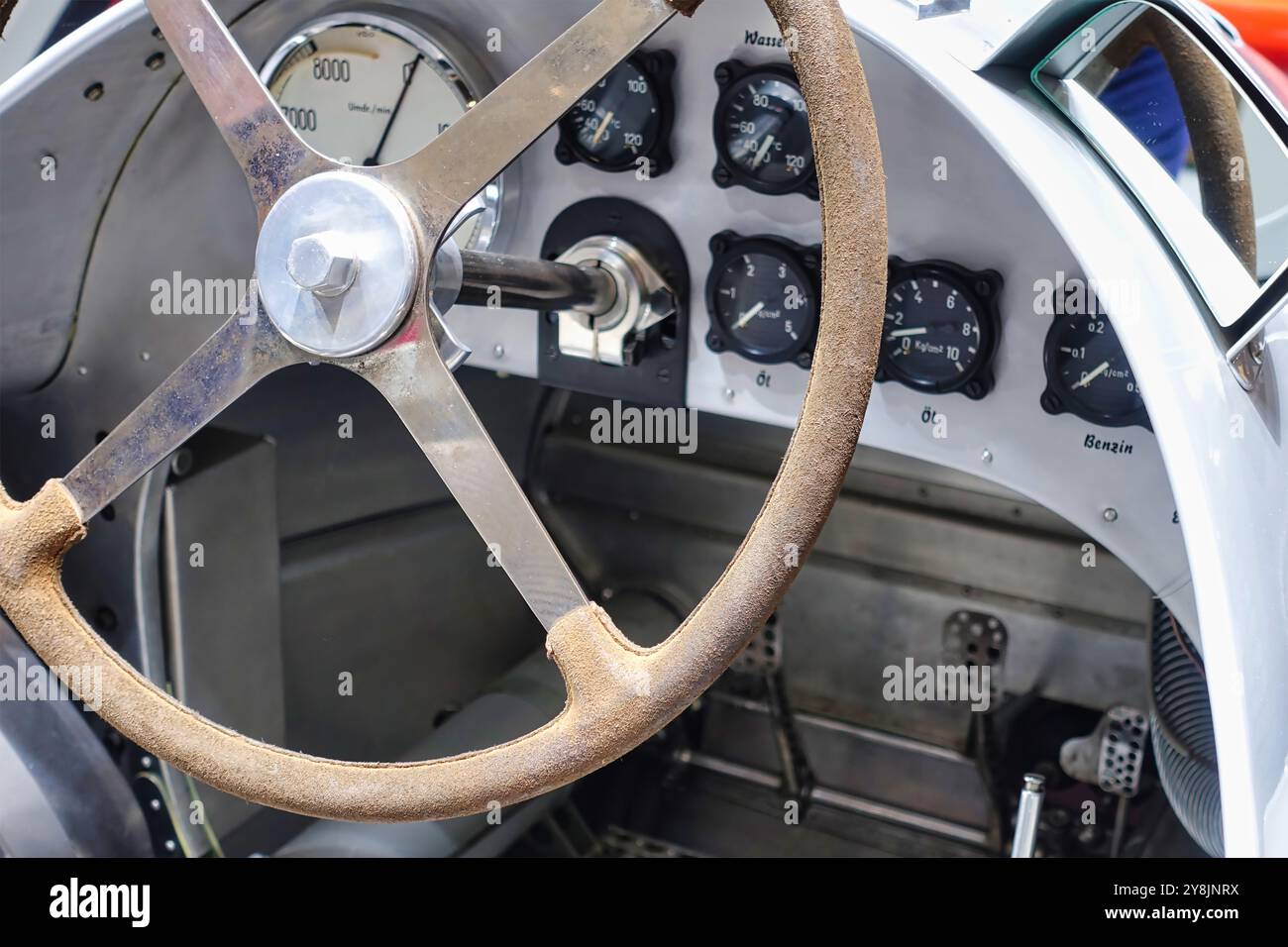 Close-up of a leather steering wheel with a view of the old dashboard ...