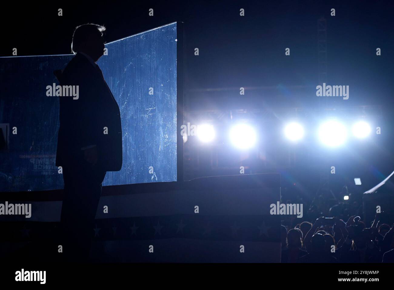 Republican presidential nominee former President Donald Trump listens ...