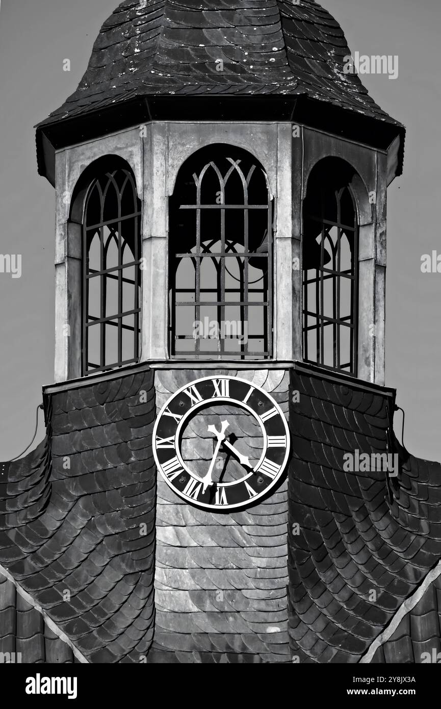 Detail of a slate-covered bell tower with an antique clock, in black ...