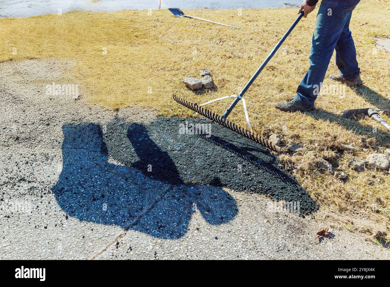 Potholes on road are repaired by asphalting damaged asphalt Stock Photo ...