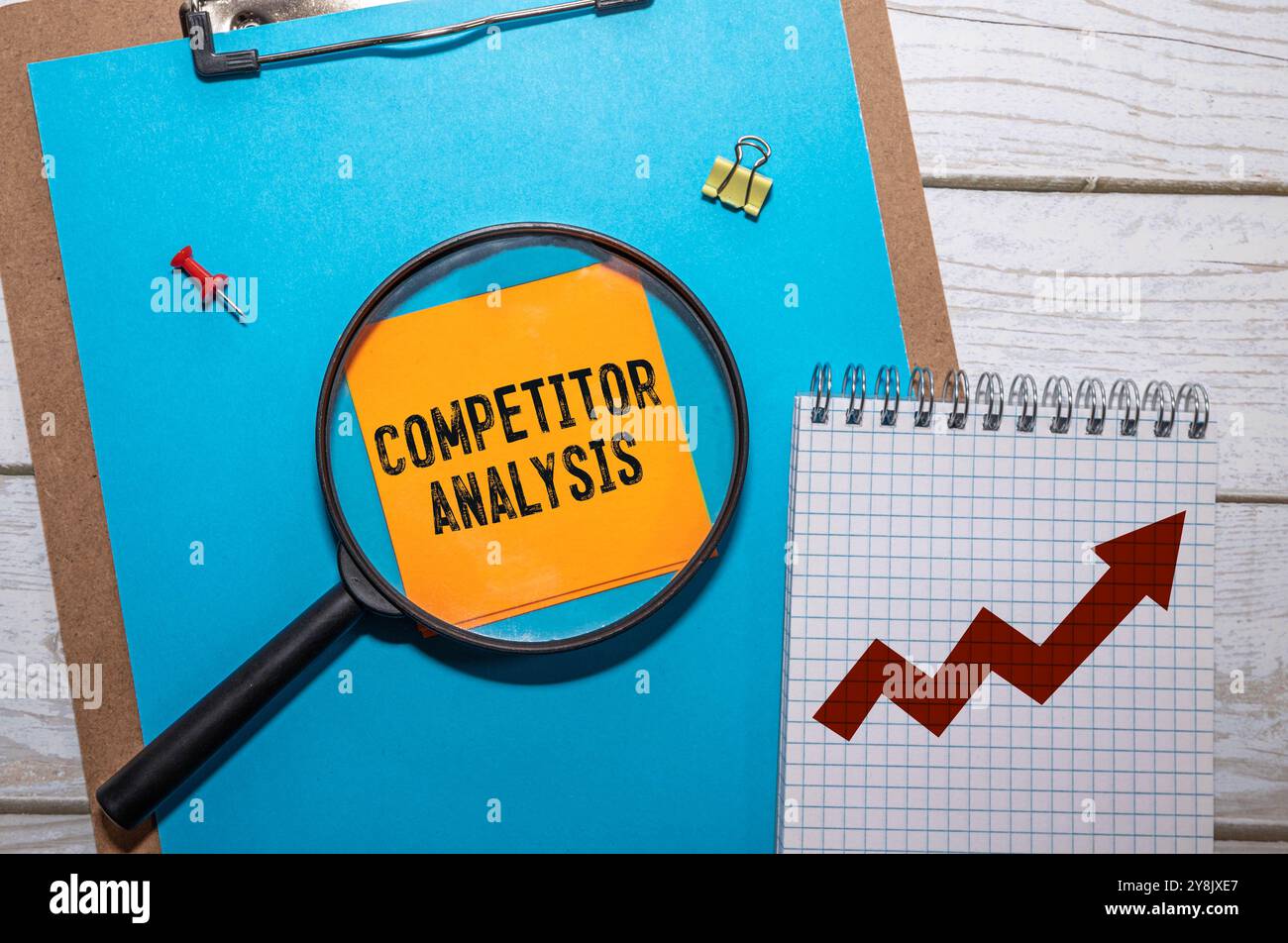 COMPETITOR ANALYSIS text on sticky on red notebook on chart background ...