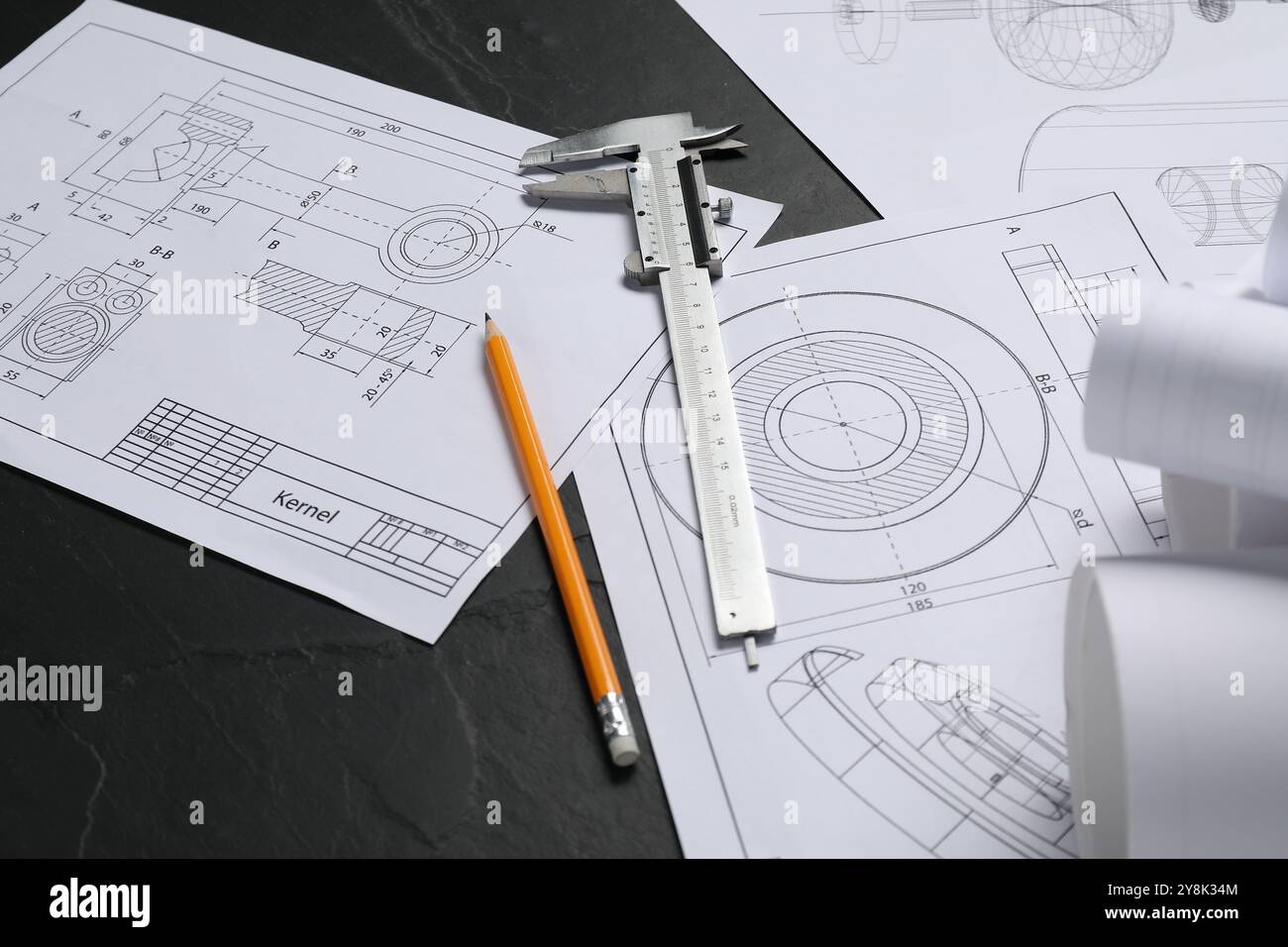 Different engineering drawings, ruler and pencil on grey textured table ...