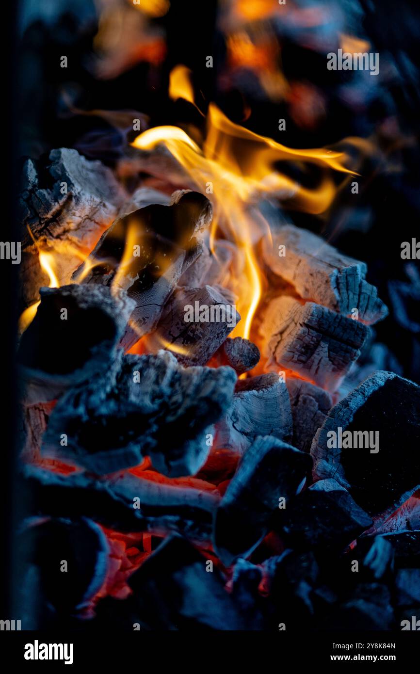 burning charcoal barbecue grill, fire burning in a evening blue light ...