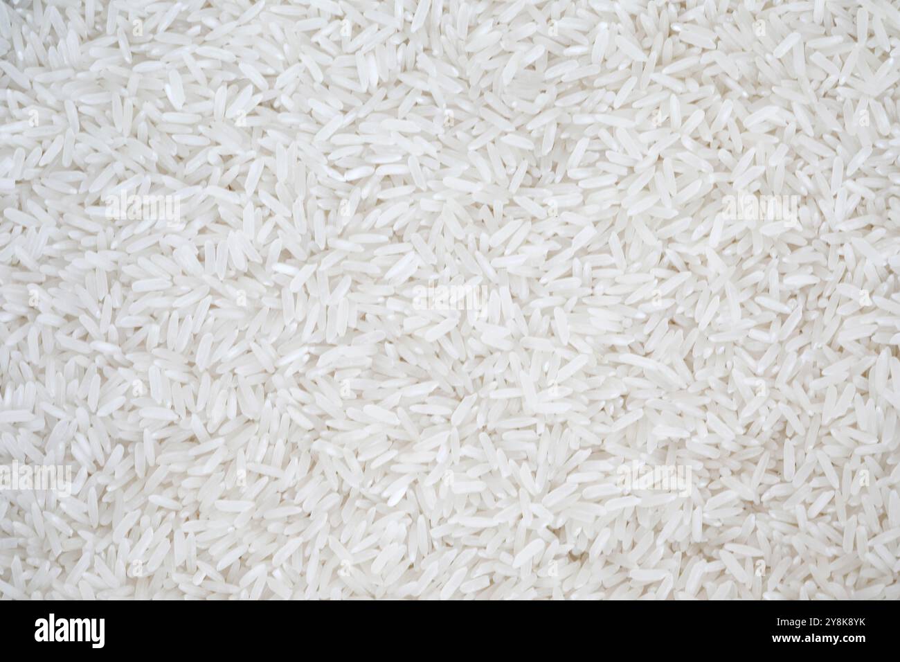 Jasmine or Basmati rice grains background Stock Photo - Alamy
