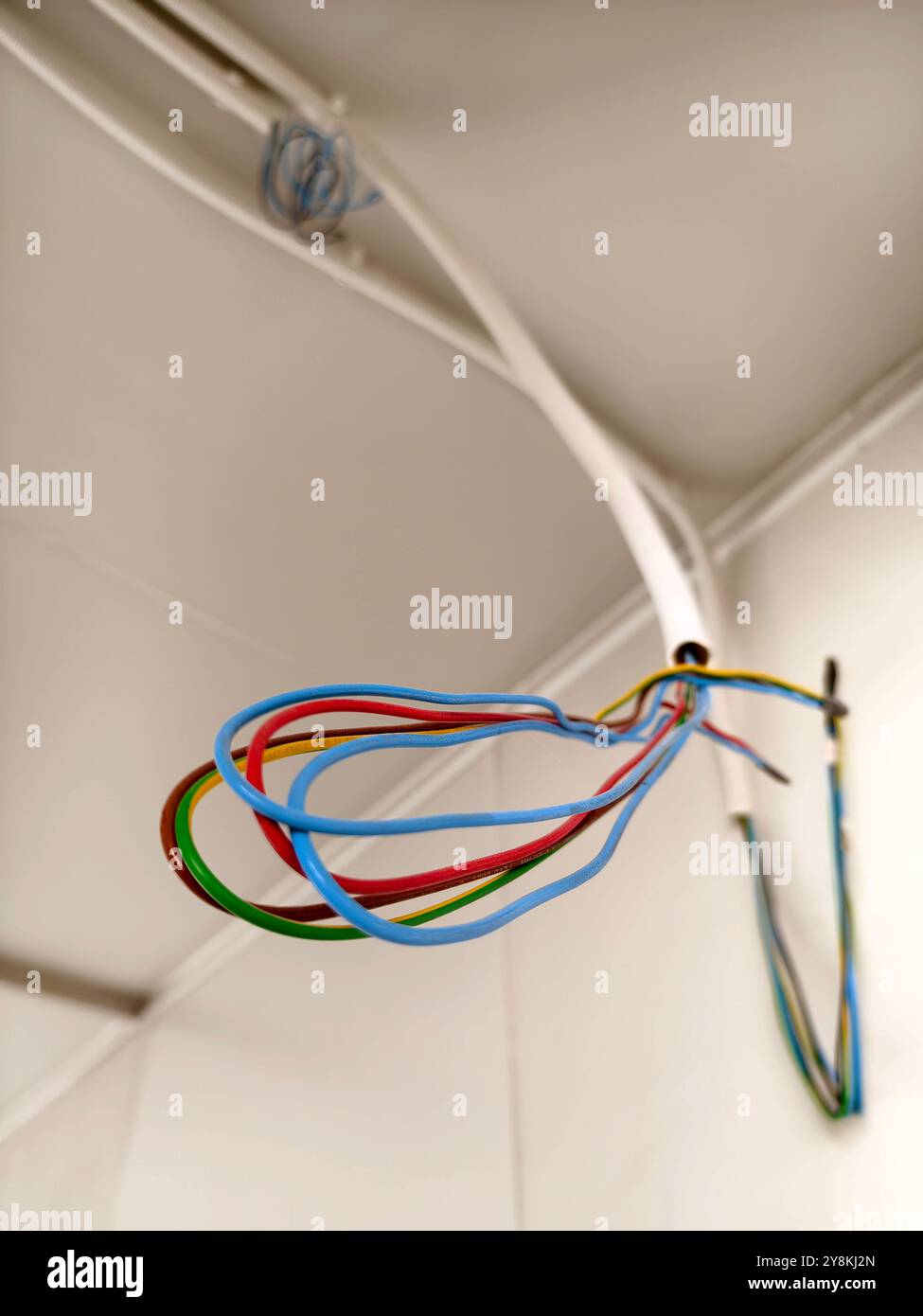 A collection of various wires is hanging down from the ceiling Stock ...