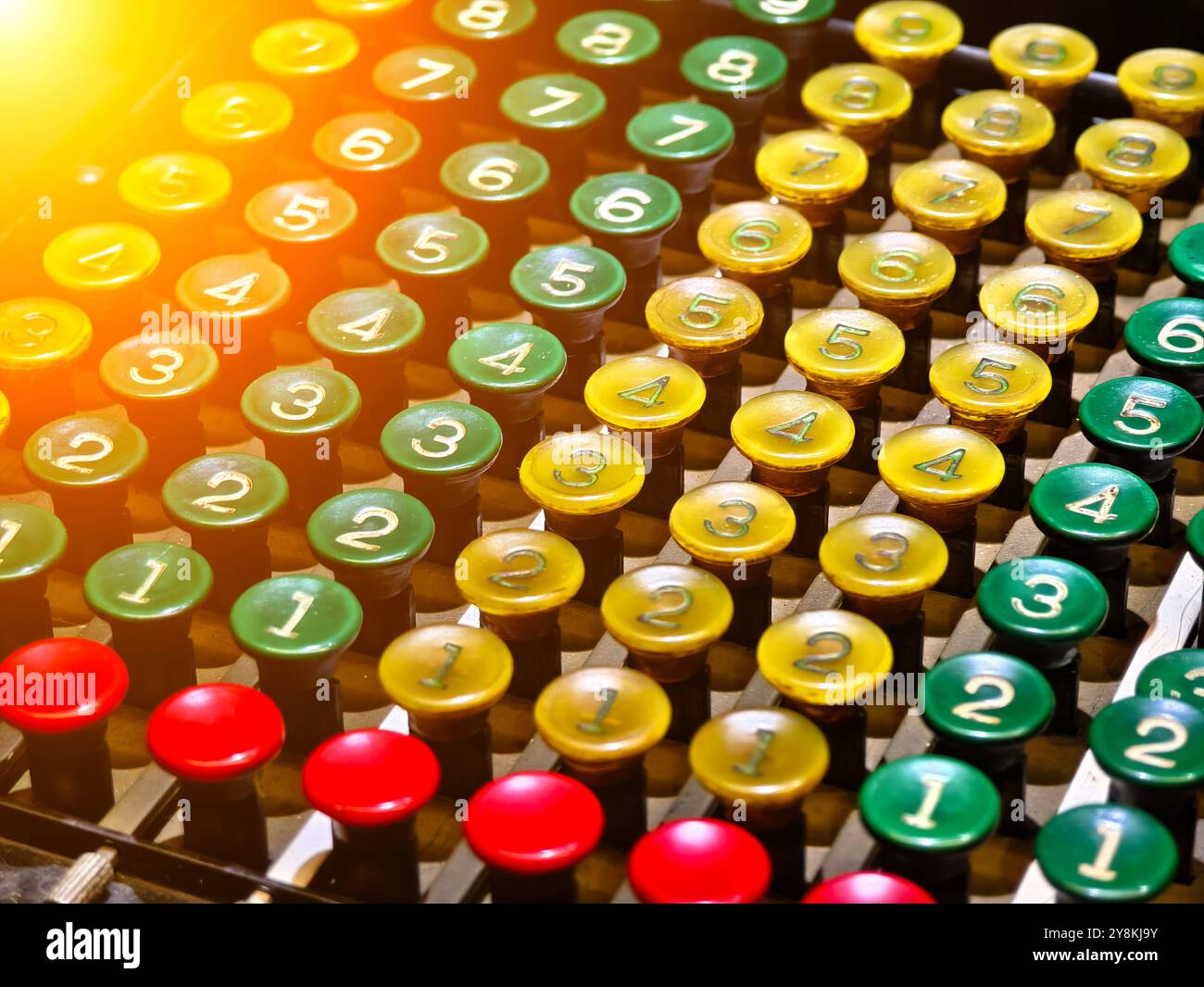 An old fashioned adding machine features a drawer located underneath it ...