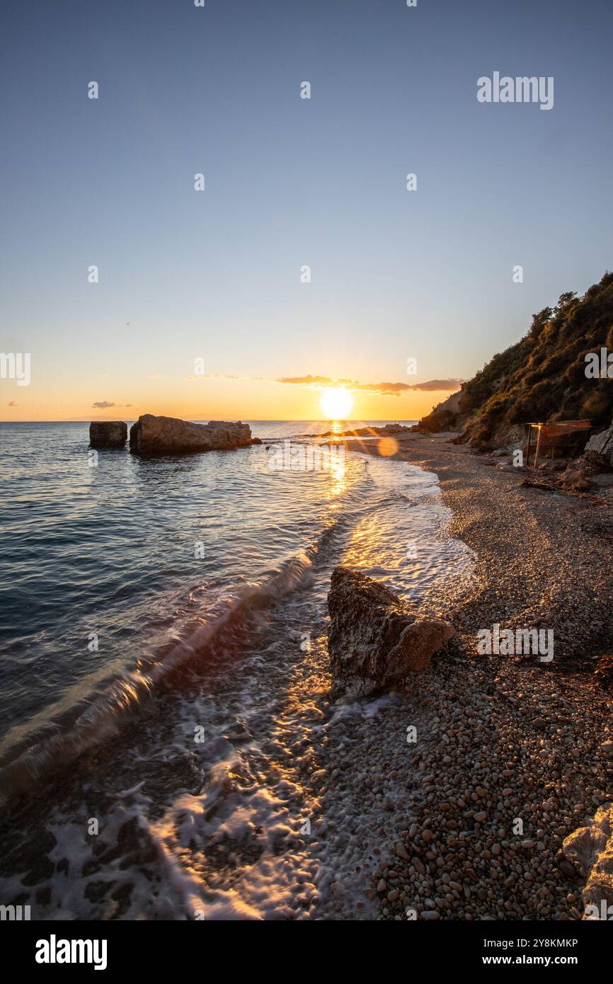 Hidden cove at sunrise. View of the fine pebble beach in the morning ...