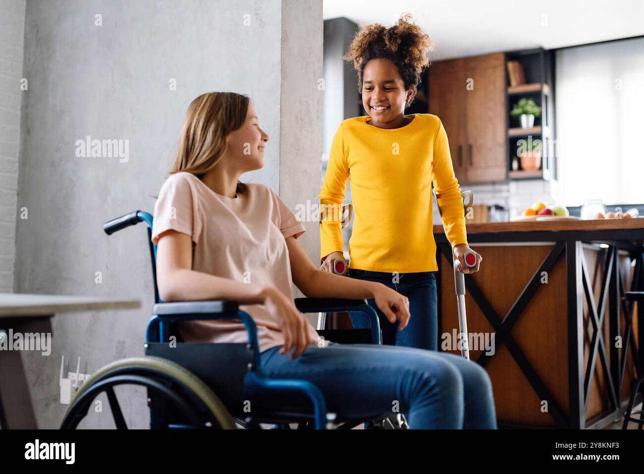 Happy multiethnic children with disability. Wheelchair and crutch Stock ...