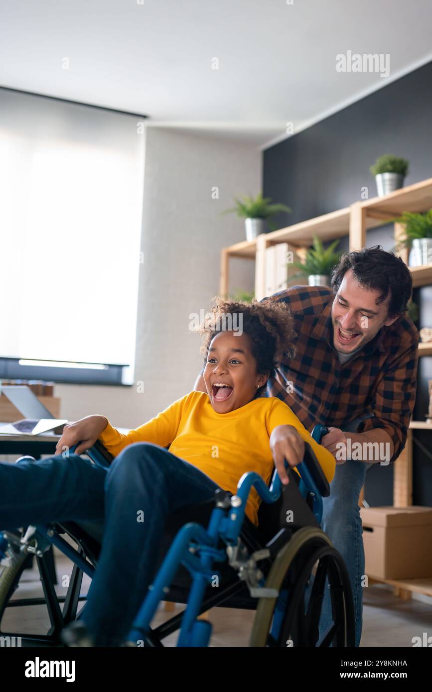 Happy multiethnic family with child with disability in wheelchair Stock ...