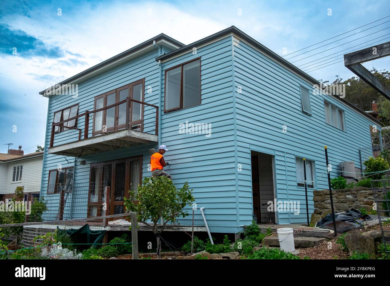 Painter on a ladder painting an old timber/weatherboard house Stock ...