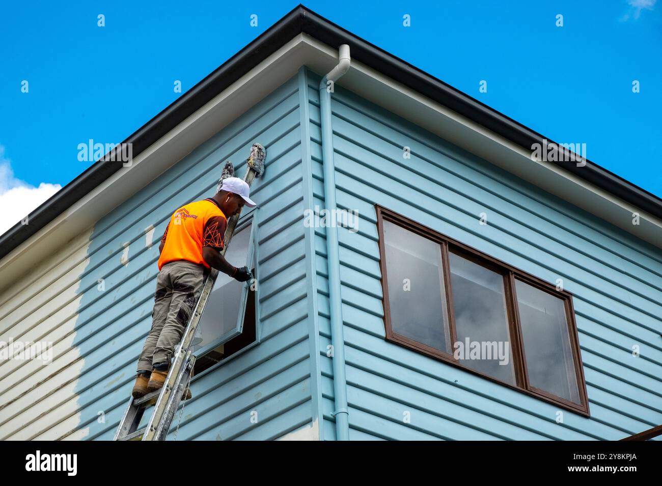 Painter on a ladder painting an old timber/weatherboard house Stock ...