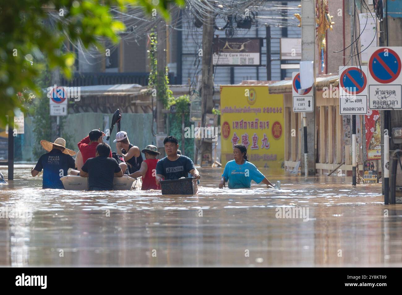 People wade through floodwaters in Chiang Mai Province, Thailand ...