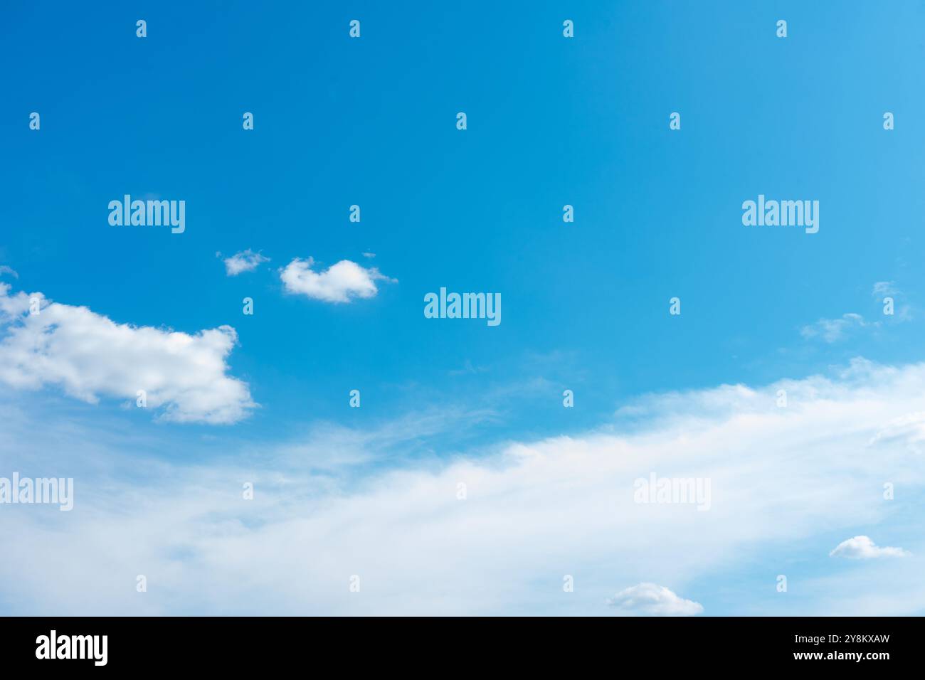 A calm blue sky with scattered white clouds on a sunny day Stock Photo ...