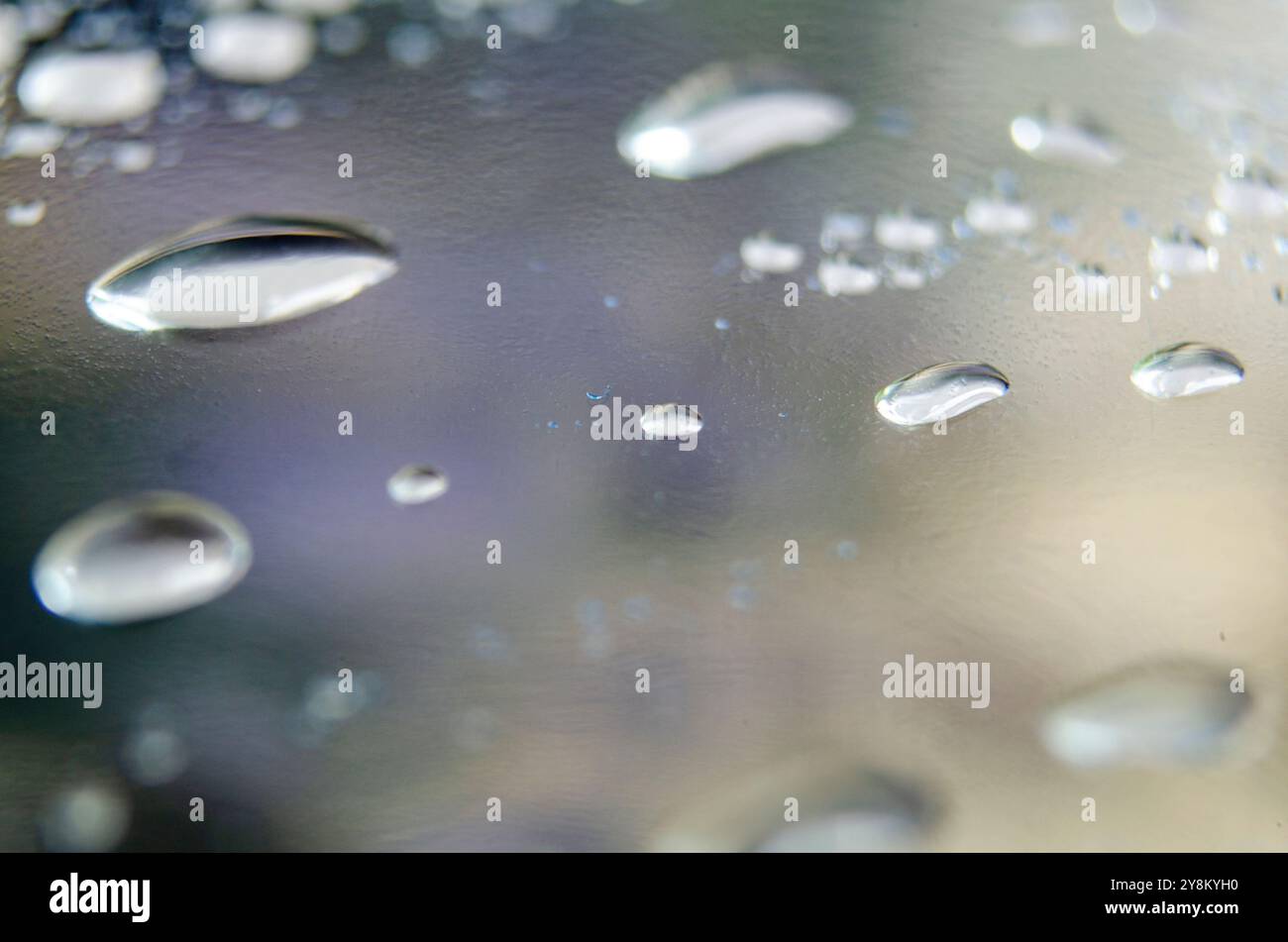 Side angle of clear raindrops on a transparent surface. Rain ...