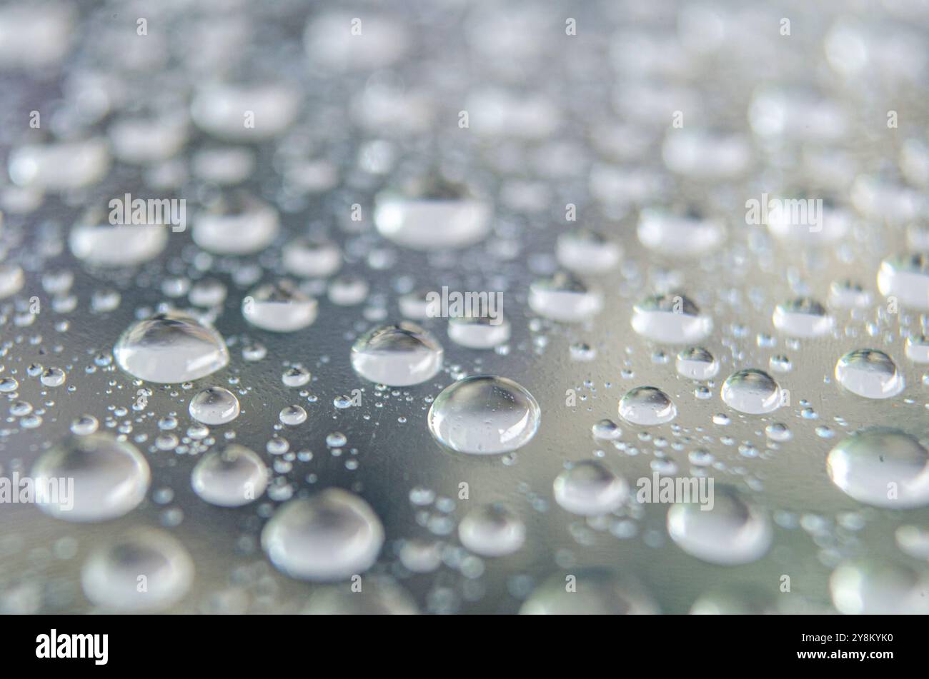 Side angle of clear raindrops on a transparent surface. Rain ...