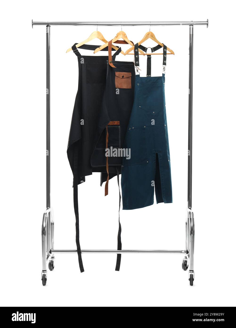 Three aprons on clothing rack isolated on white Stock Photo - Alamy