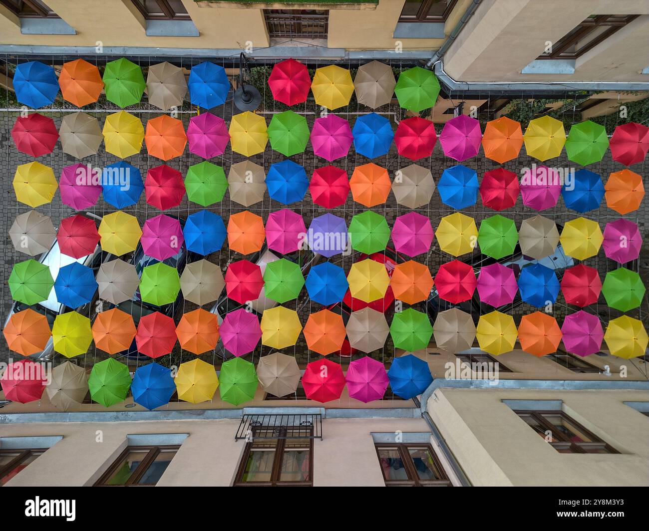 Vibrant Overhead Display of Multicolored Umbrellas Hanging Between Two ...