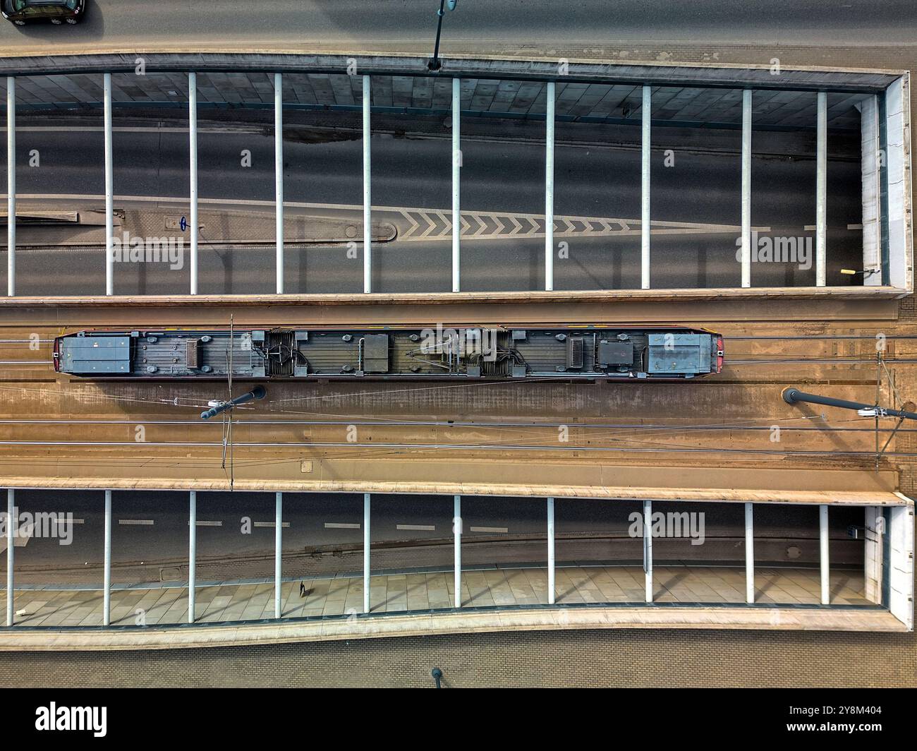 Aerial View of a Single Tram Traveling on a Bridge Over a Road in Łódź ...