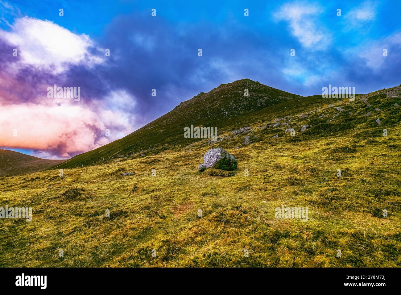 A mountain range with multiple peaks in the distance is partially ...
