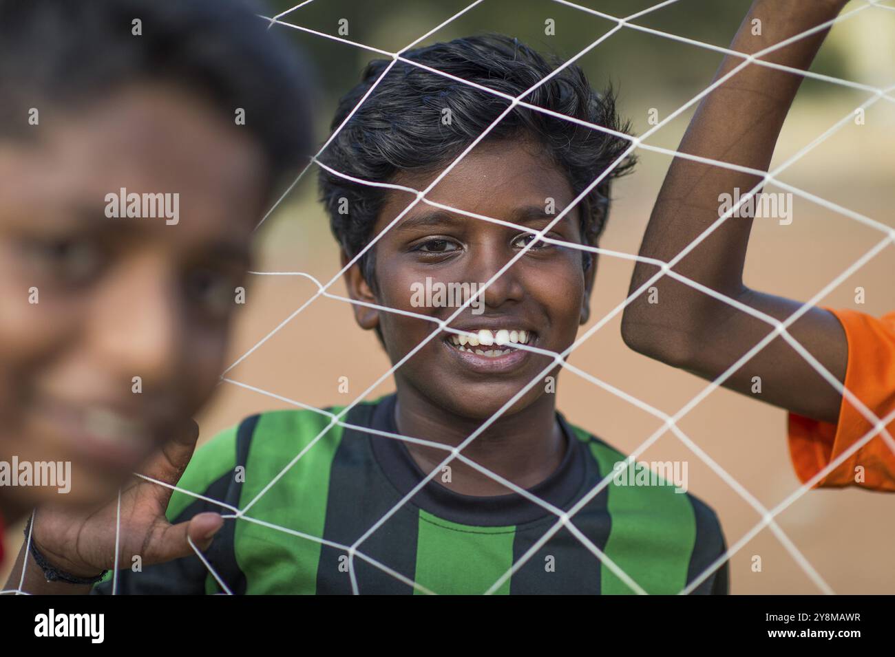 Laughing boys looking through goal net, football, Parade Ground, Fort ...