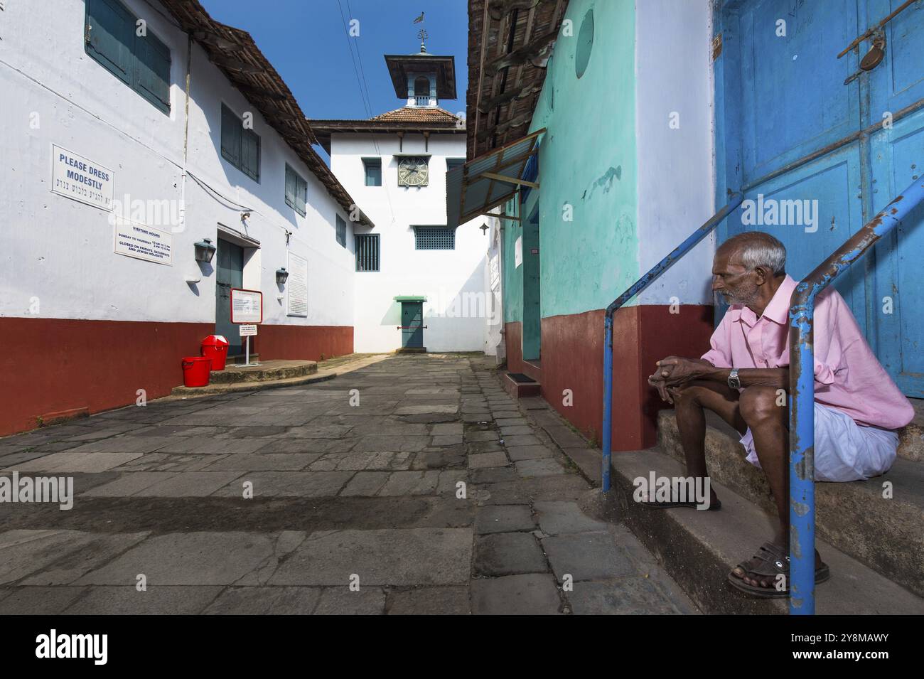 Man sitting on stairs near Paradesi Synagogue, Jewish Quarter or Jew ...