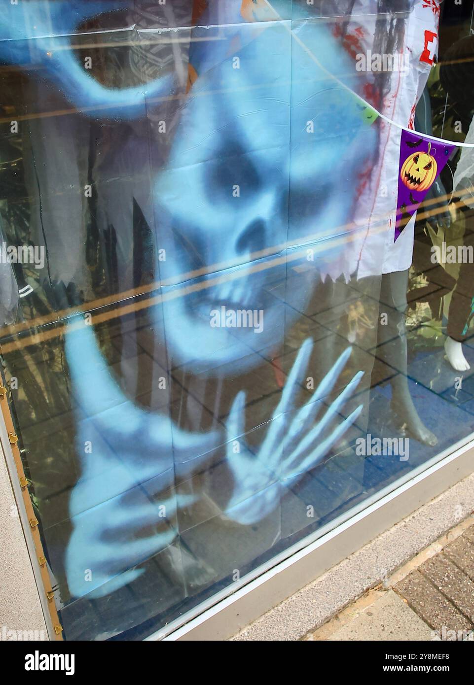 Ghosts and ghouls in a window display getting ready for Halloween 2024 ...