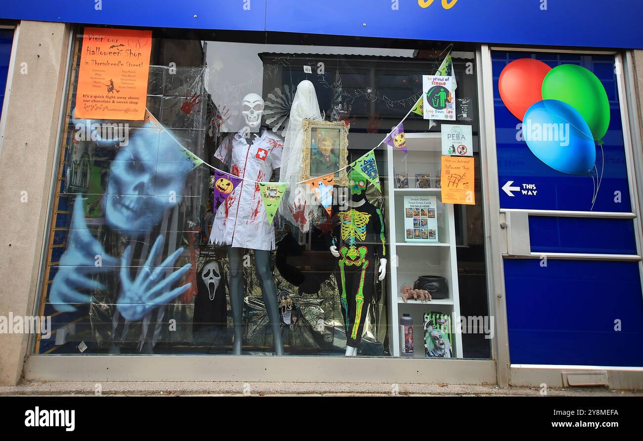 Ghosts and ghouls in a window display getting ready for Halloween 2024 ...