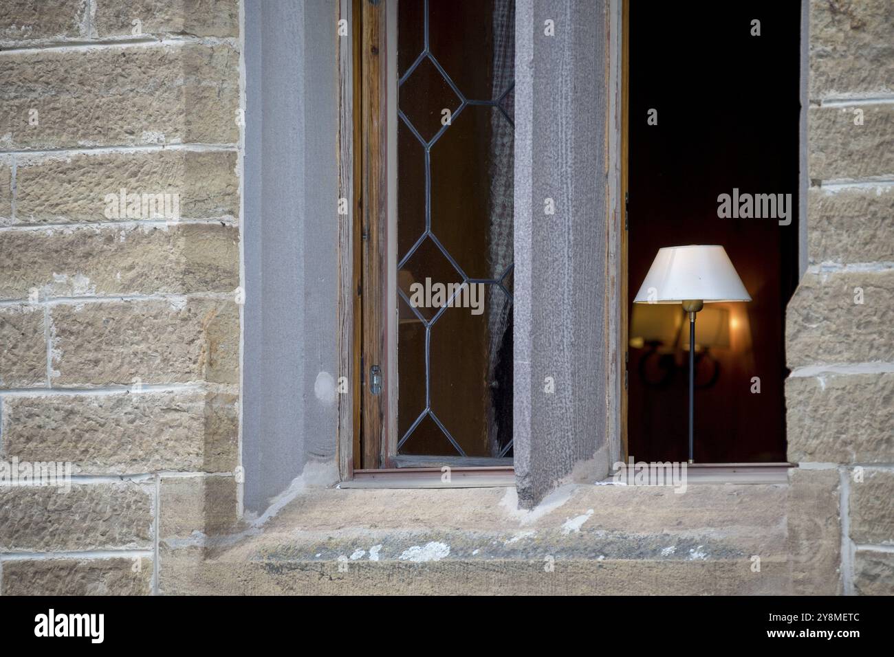 Lone lamp in the window Stock Photo - Alamy
