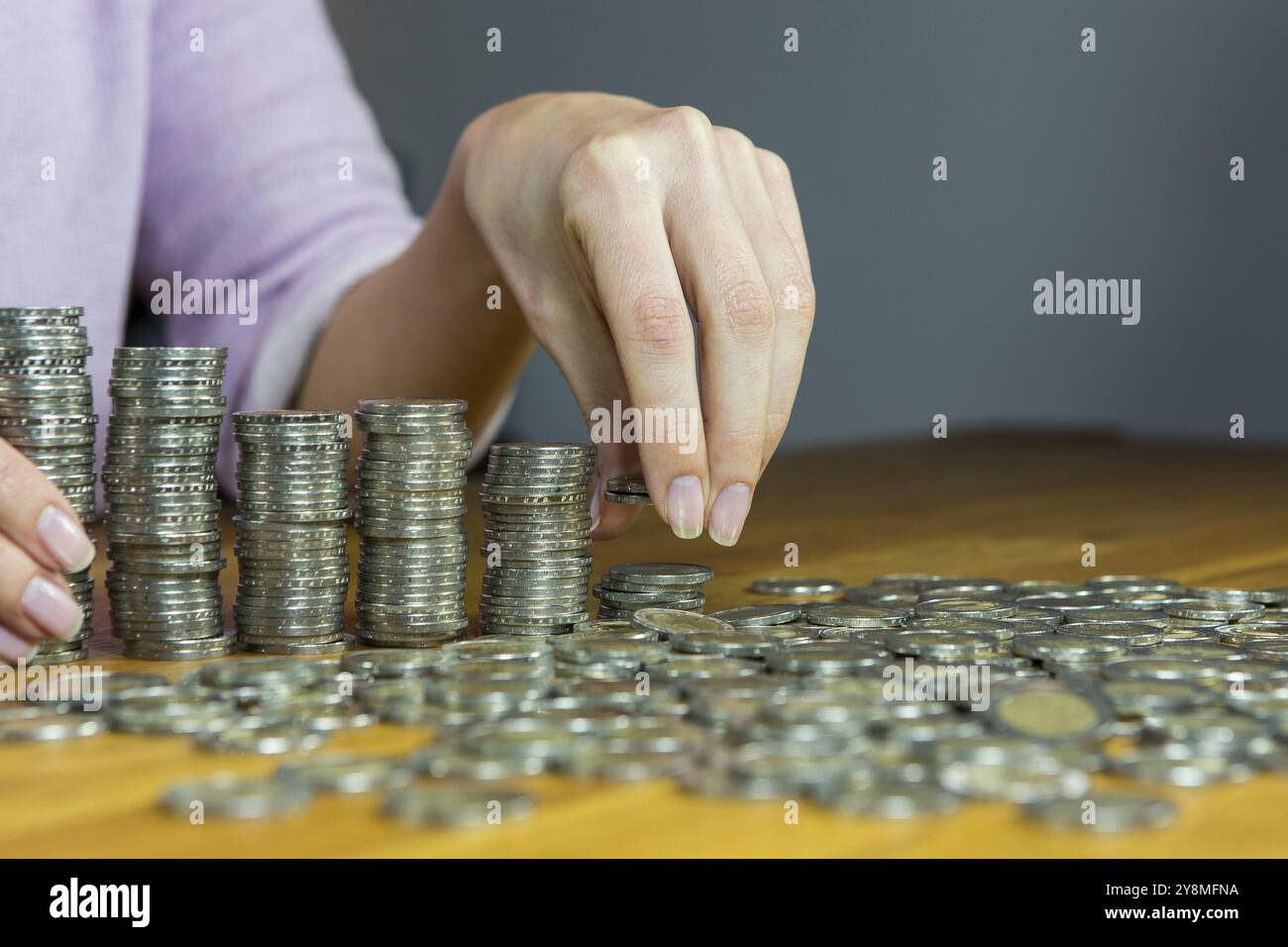 Building money towers Stock Photo - Alamy